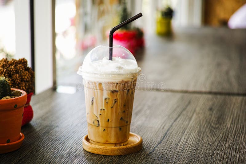 Cold Iced Coffee in Plastic Glass on Table in the Coffee Cafe Stock ...
