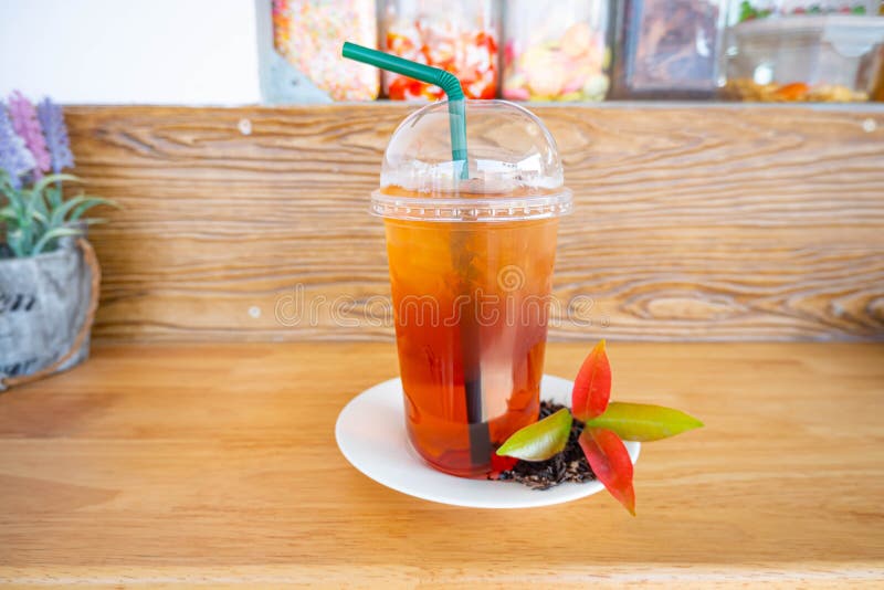 Cold Iced Tea in Takeaway Plastic Cup with Green Straw and Beautifully ...