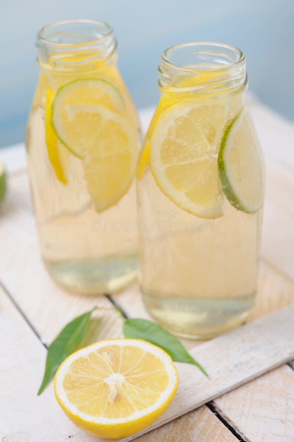 Cold Lemon Drink with Slices of Lime and Lemon Stock Image - Image of ...