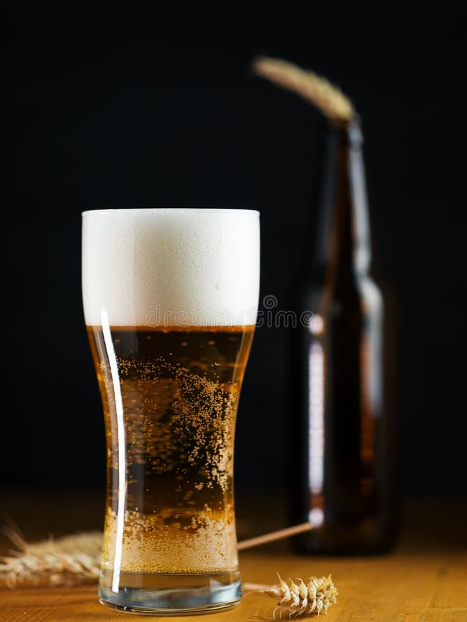 Cold Light Beer Lager in a Glass on a Dark Table Stock Image - Image of ...