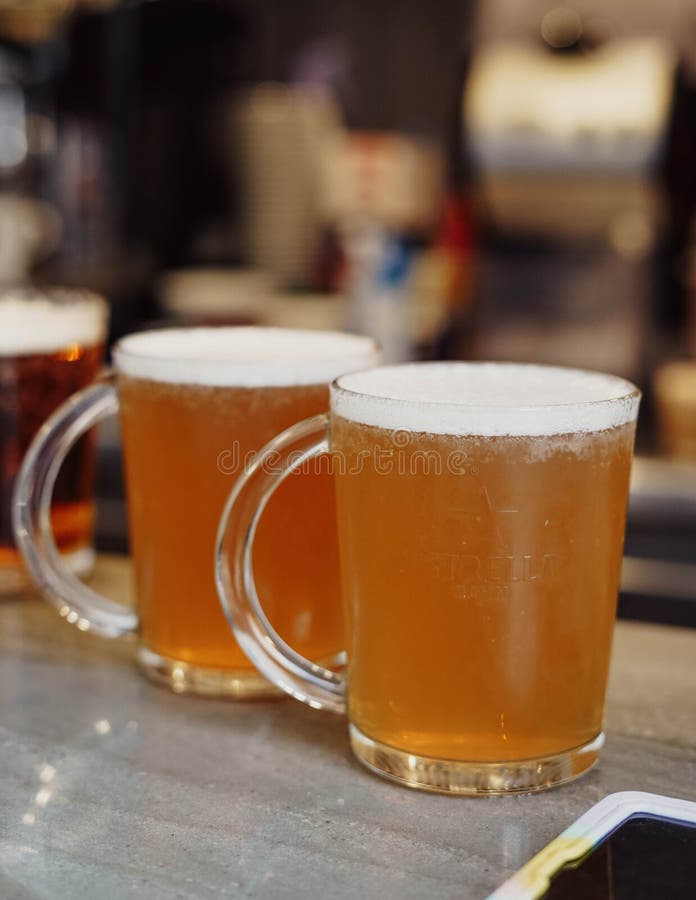 Cold Mugs of Beer on a Terrace Table Stock Image - Image of counter ...