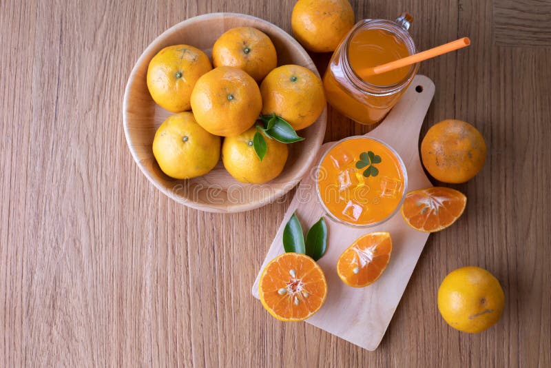 Cold Orange Juice and Sliced Orange on Wood Table Stock Photo - Image ...