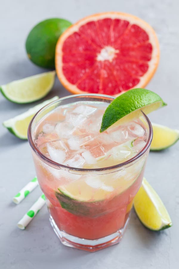 Cold Pink Cocktail with Fresh Grapefruit, Lime and Ice, Vertical Stock ...