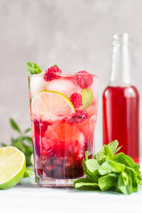 Cold Pink Non-alcohol Cocktail with Raspberry, Lime, Mint and Ice Cubes ...