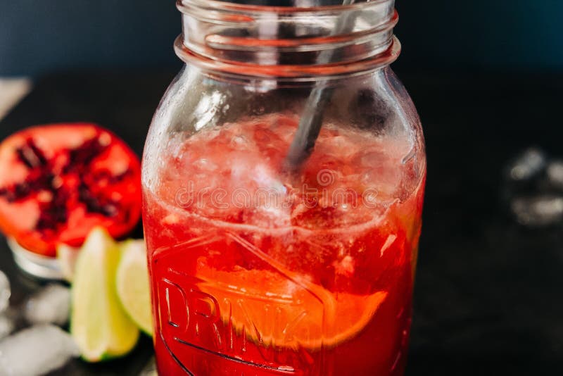 Cold Red Drink Made with Fruits, Lime and Mint on the Table Stock Photo ...