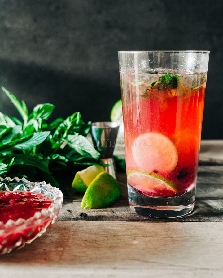 Cold Red Drink Made with Fruits, Lime and Mint on the Table Stock Image ...