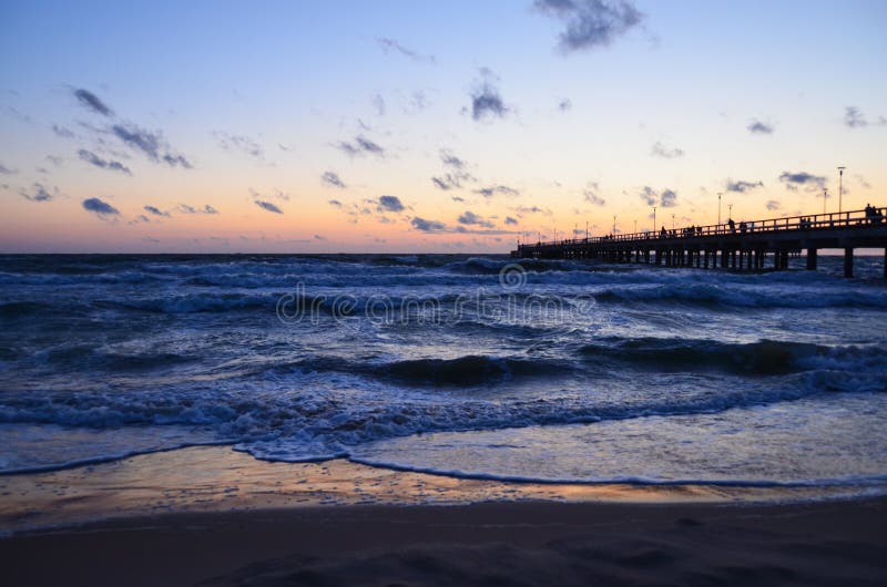 Cold sea stock photo. Image of sunset, clouds, jetty - 94840676