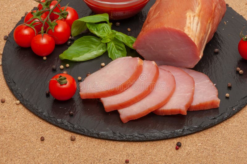 Cold Smoked Meat with Sauce, Cherry Tomatoes and Basil on a Black ...