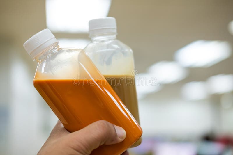 Cold Thai Milk Tea and Cold Coffee in Plastic Bottles on Hand Stock ...