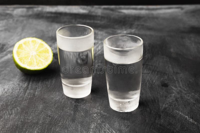 Cold Vodka in Shot Glasses on a Black Background Stock Image - Image of ...