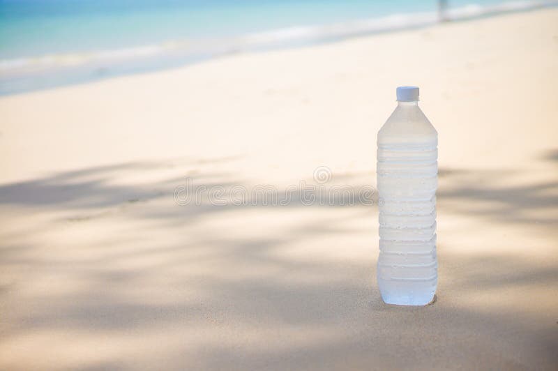 Glass Of Water With Drops And Small Shells On Pool Side In Tropical ...