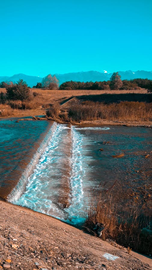 Cold Water River with Mountains in the Background with Blue Sky Stock ...