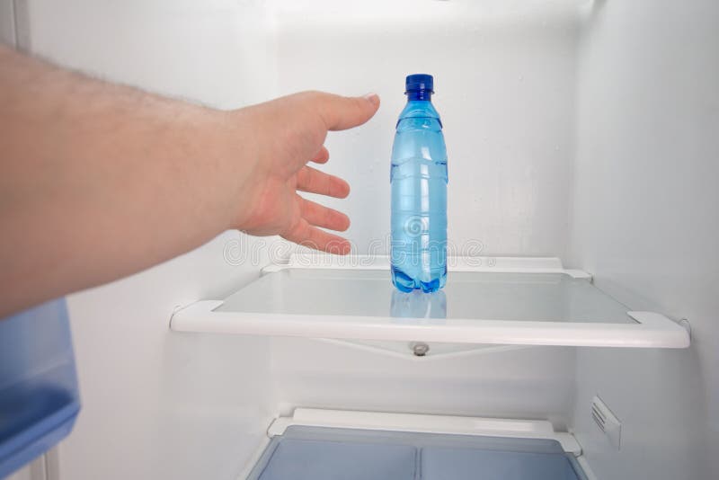 Cold Water on a Shelve in an Empty Fridge. Stock Image - Image of ...