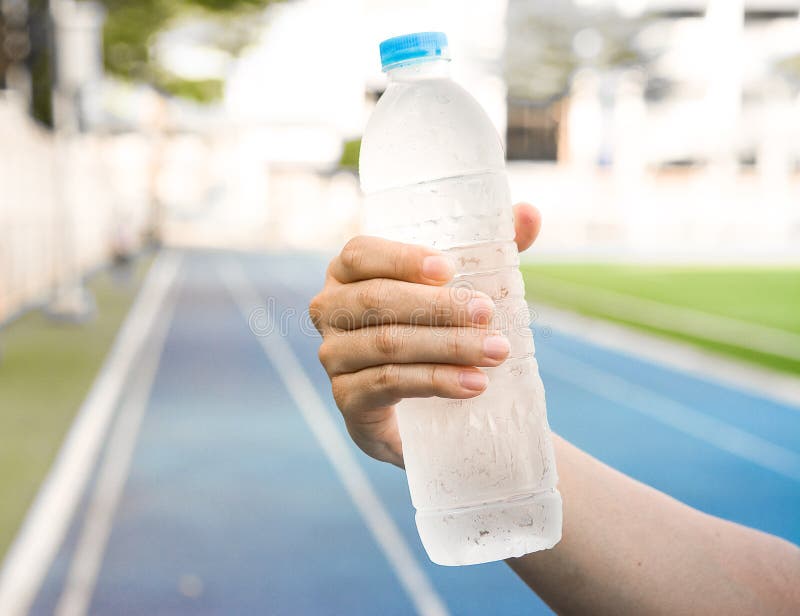 Cold Water in Transparent Bottle is Holding in One Hand for Refresh ...