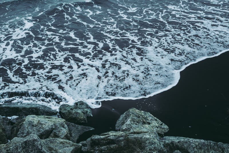 Cold Waters of Atlantic Ocean on Black Sand Beach in Iceland. View from ...