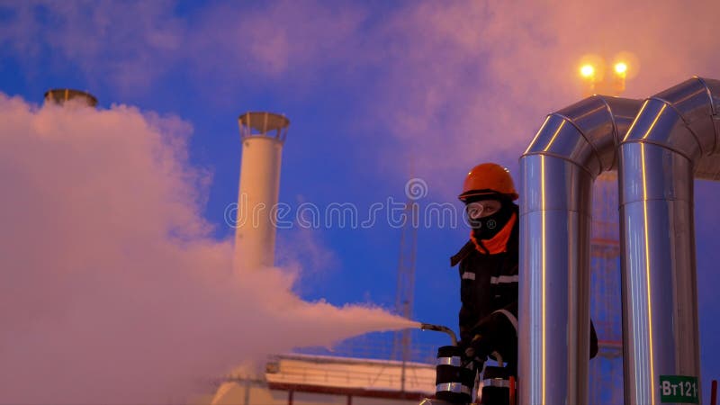 Cold Weather Industrial Operations, Worker in Protective Gear Managing ...