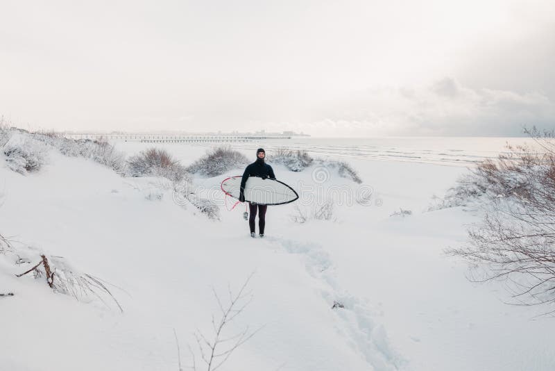 Cold Winter and Surfer with Surfboard. Snowy Day with Surfer in Wetsuit ...