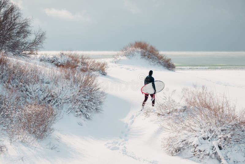 Cold Winter and Surfer with Surfboard. Snowy Day with Surfer in Wetsuit ...