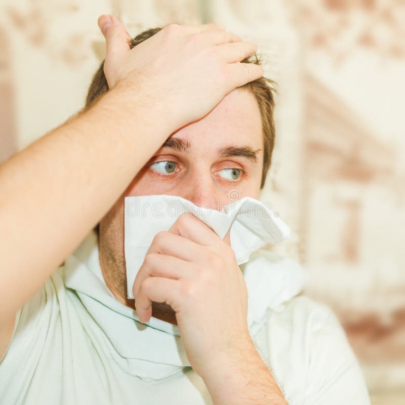 A Young, Cold Man in a Facial Gauze Bandage Holds a Sick Head Stock ...