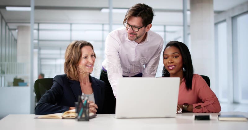 Collaborating Business Team Smiling Together on Laptop Stock Photo ...
