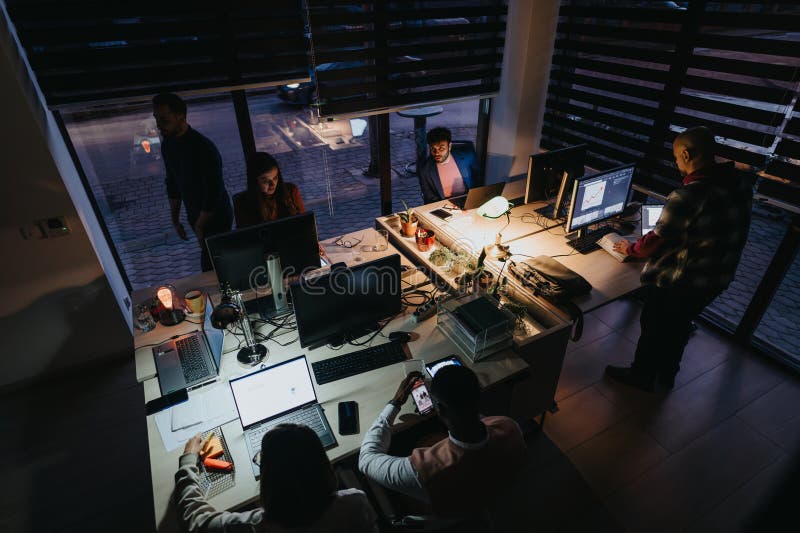 Diverse Business Team Working Late into the Night, Collaborating and ...