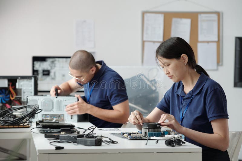 Collaborating on Electronics Repair in Modern Workspace Stock Photo ...