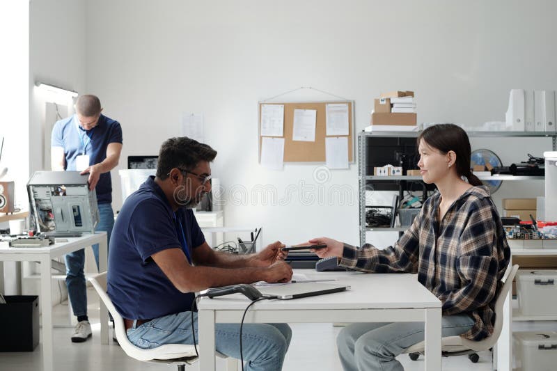 Collaborating in Modern Office Setting with Tech Gadgets Stock Photo ...