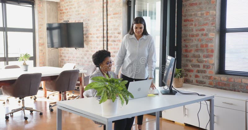 Collaborating in Modern Office, Two Women Working on Computer Together ...
