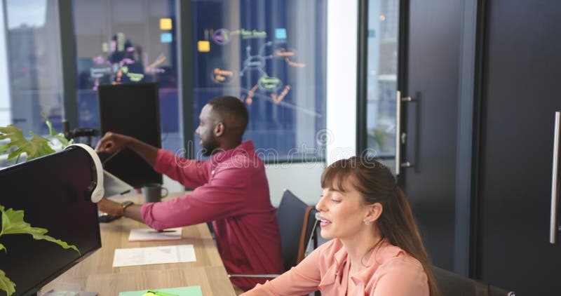 Collaborating on Project, Diverse Colleagues Using Computer and Notes ...