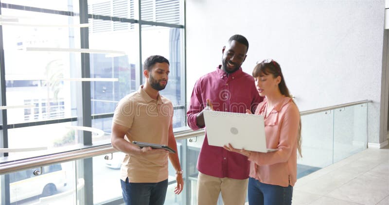 Collaborating on Project, Diverse Team Using Laptop and Tablet in ...