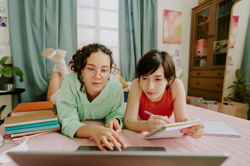 Collaborating on Study Project in Cozy Bedroom Setting Stock Photo ...