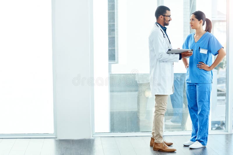 Collaborating Their Way To a Conclusion. Two Young Doctors Using a ...