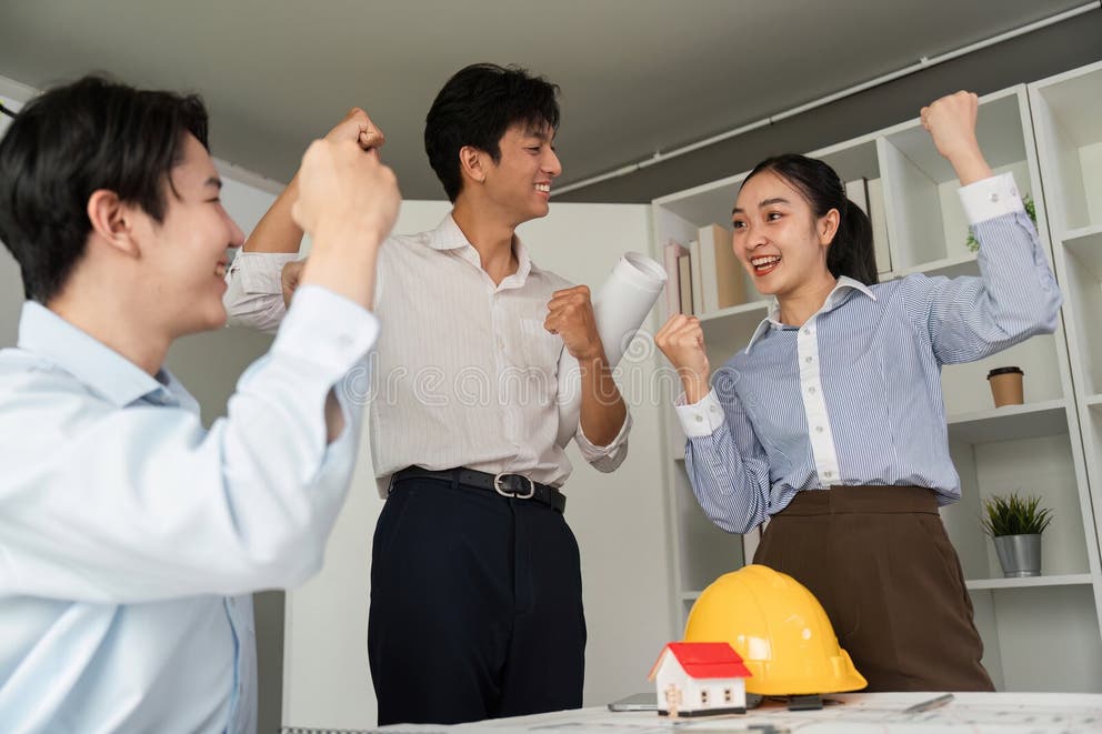 Collaboration and Achievement. a Team of Architects Cheering after ...