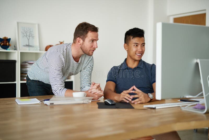Collaboration, Computer and Design with Business Men at Desk in Office for Project Management ...