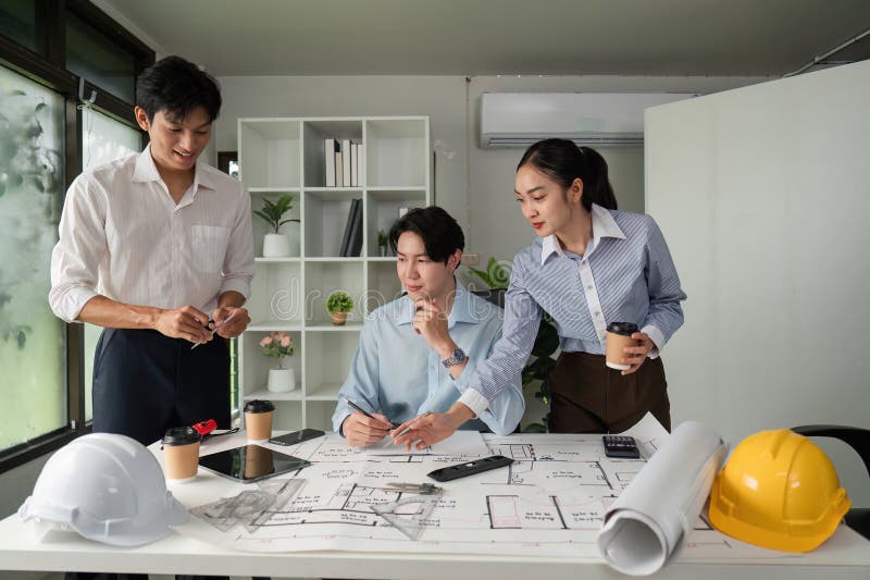 Collaboration and Planning. a Group Discussing Architectural Plans and ...