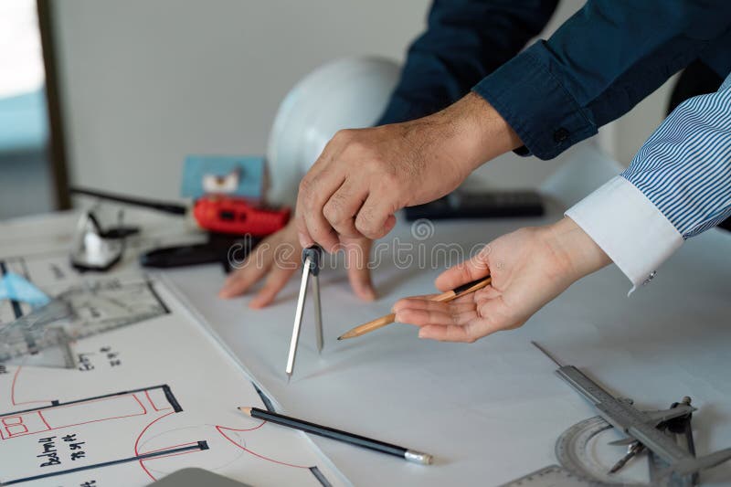 Collaborative Architects Discussing Design Plans with Compass and ...