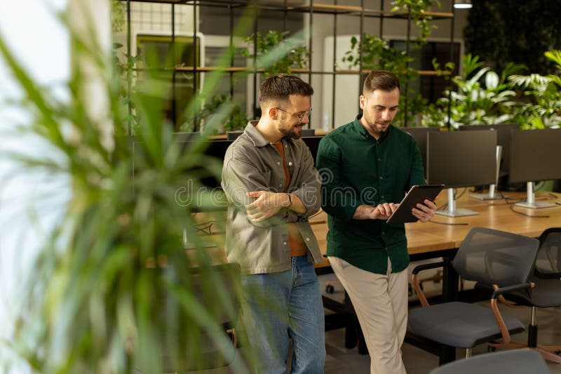 Collaborative Discussion in a Modern Office with Exposed Brick Walls ...