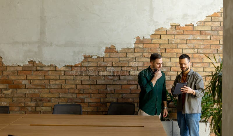 Collaborative Discussion in a Modern Office with Exposed Brick Walls ...