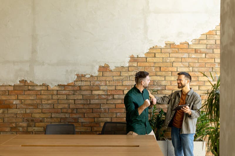 Collaborative Discussion in a Modern Office with Exposed Brick Walls ...