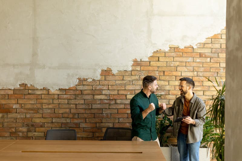 Collaborative Discussion in a Modern Office with Exposed Brick Walls ...