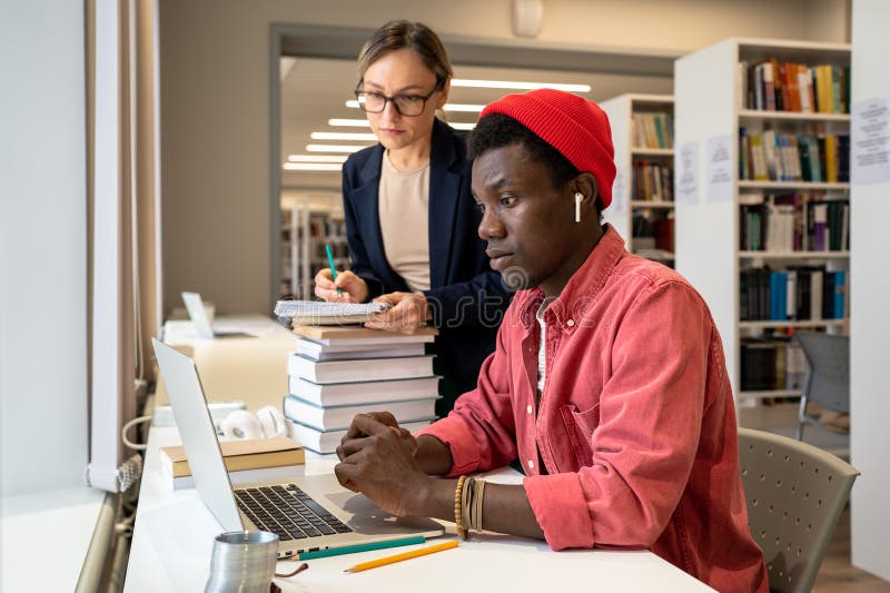 Two Diverse Students Guy and Girl Watching Webinar on Laptop while ...