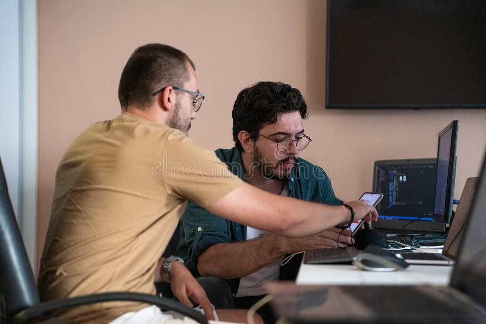 Collaborative Minds: a Team of Programmers Tackling Challenges Together in the Office. Stock ...