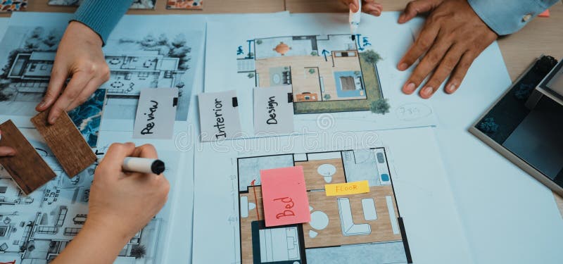Collaborative Workspace with Hands Creating Interior Design Plans on ...