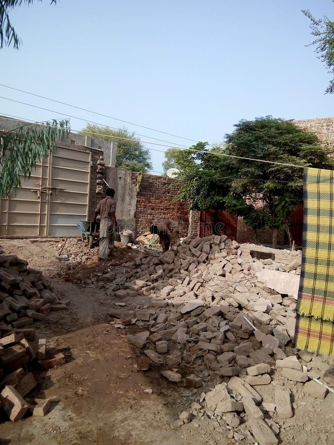 A collapsed mud house wall stock image. Image of workers - 230285585