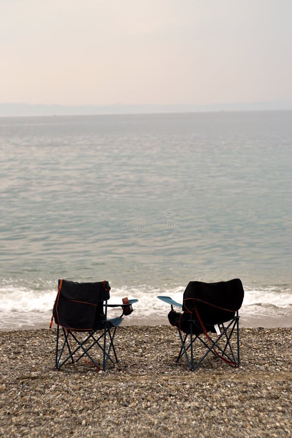 Collapsible Beach Chairs on Pebble Stone Beach Stock Image - Image of ...