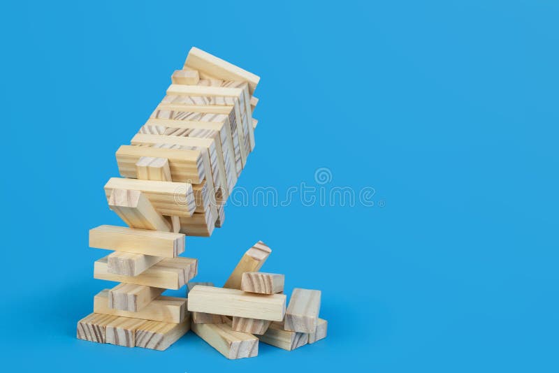Collapsing Wooden Blocks Tower on Blue Background, Close Up with Copy ...