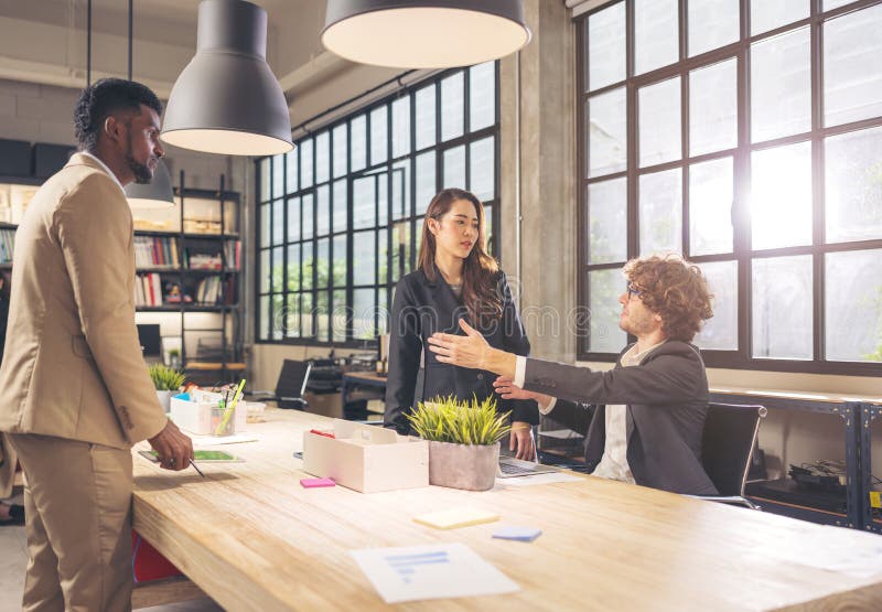 Colleagues in a Boardroom Discussion, Seated at a Table Together ...