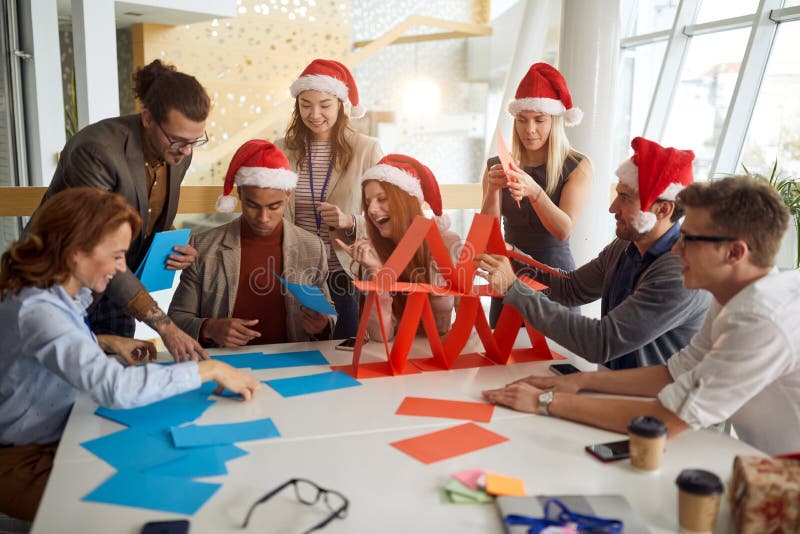 Colleagues Building Paper Towers at Work in the Office for Christmas ...