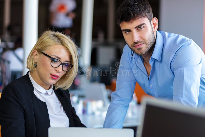 Colleagues Chatting, Sitting Together at Office Table, Smiling Stock ...