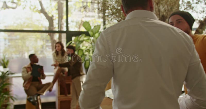 Colleagues Collaborate and Share Ideas in a Vibrant Workplace Setting ...